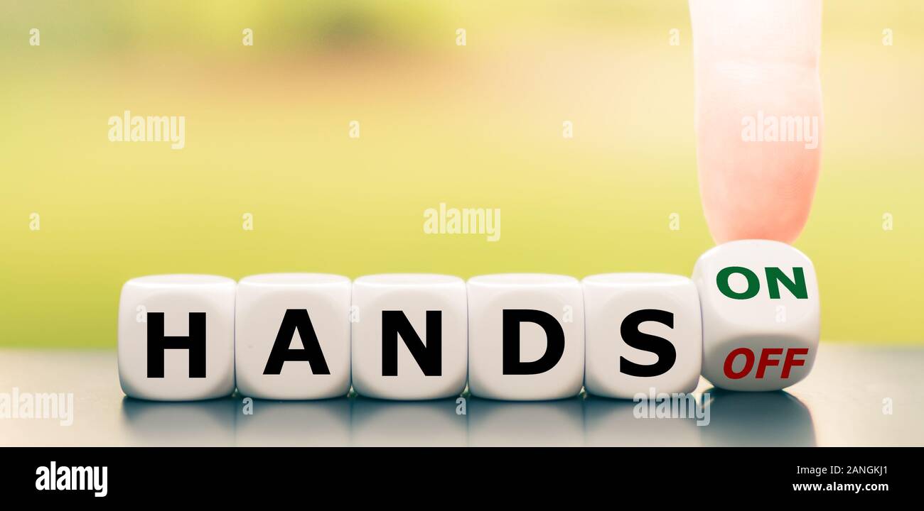 Finger turns a dice and changes the expression "hands off" to "hands on ...