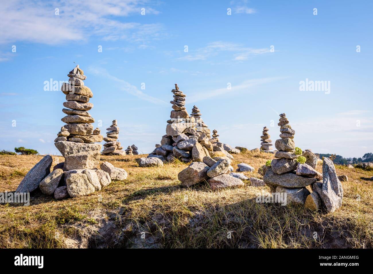 Many man-made granite stone stacks (called cairns) on the coastal path ...