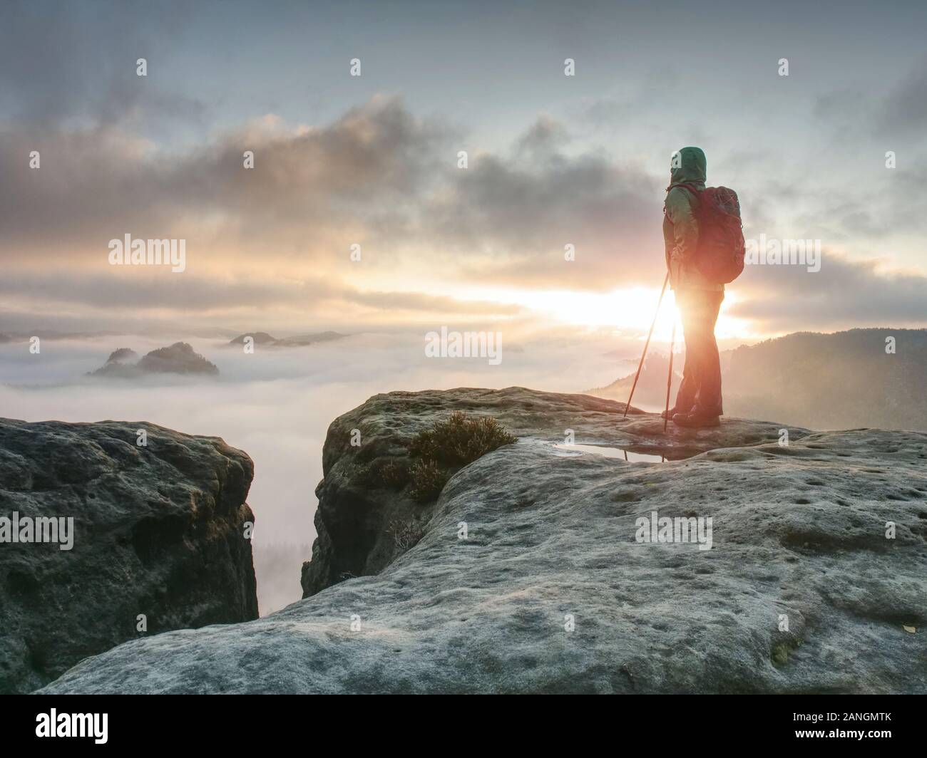 Woman hiker stop at the end of path on the edge. View from sharp cliff ...