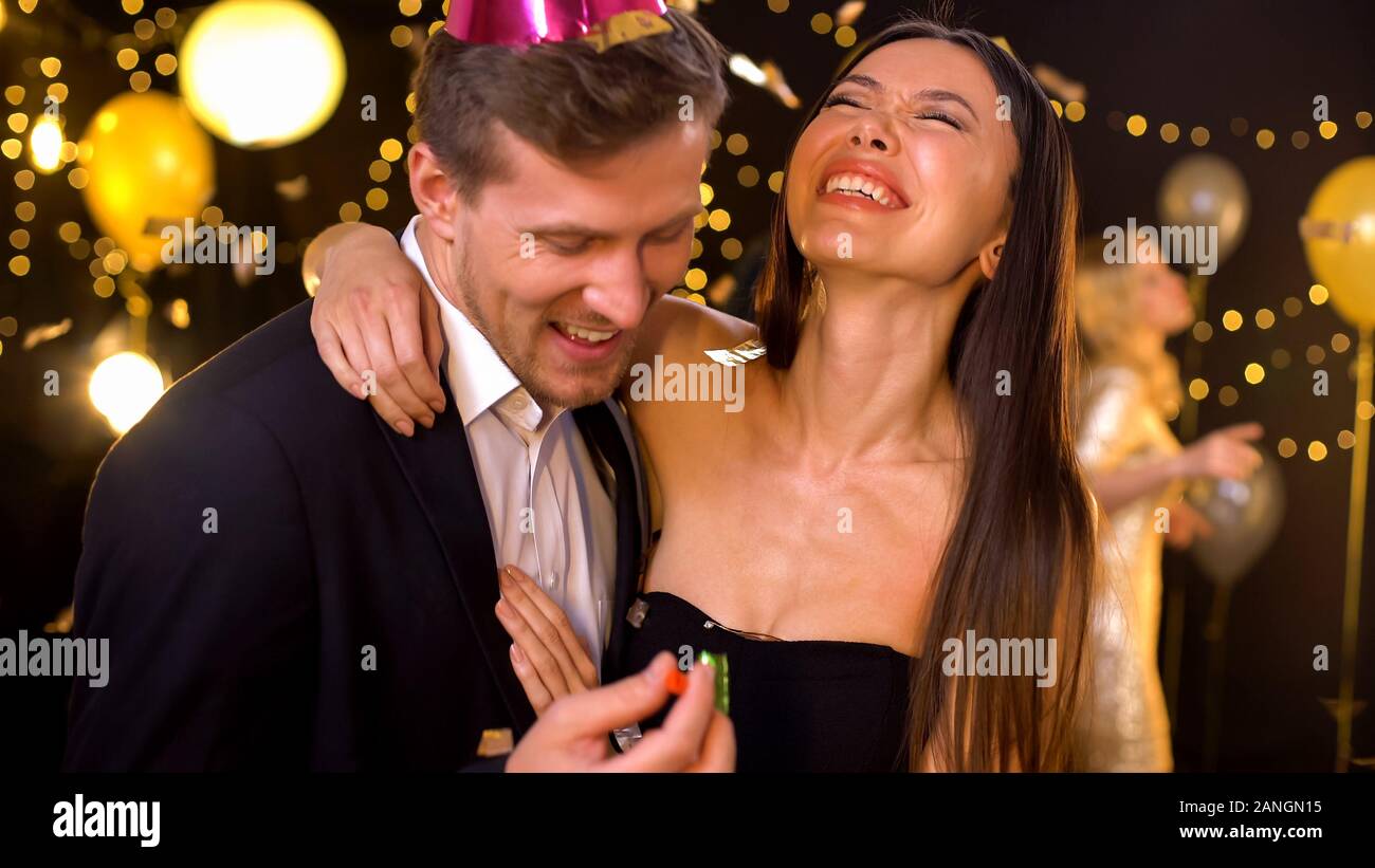Cheerful couple laughing, alcohol intoxication, having fun at New Year ...