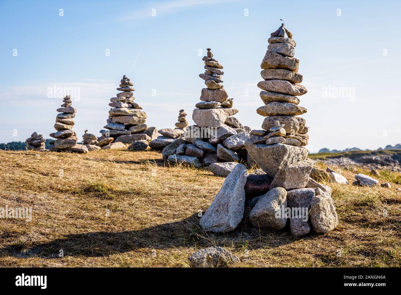 Many man-made granite stone stacks (called cairns) on the coastal path ...