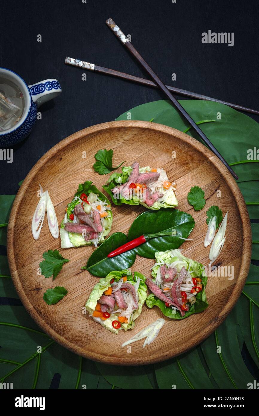 Spicy thai beef and lettuce canape with glass noodles Stock Photo - Alamy
