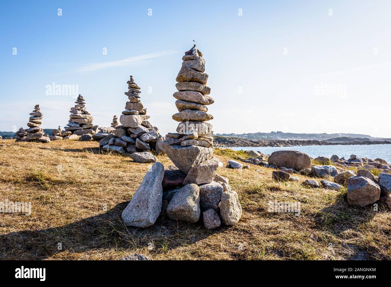 Many man-made granite stone stacks (called cairns) on the coastal path ...
