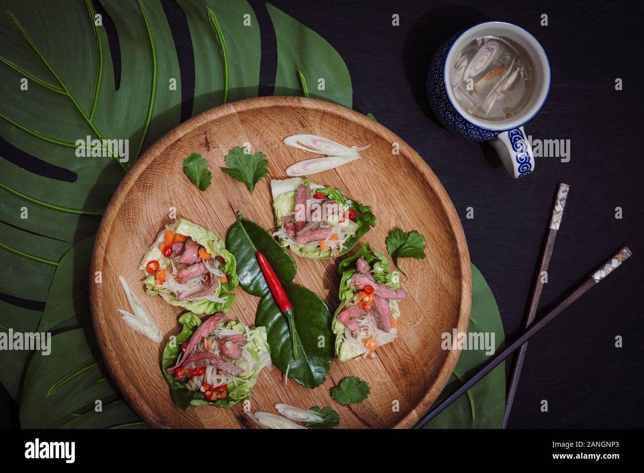 Spicy thai beef and lettuce canape with glass noodles Stock Photo - Alamy