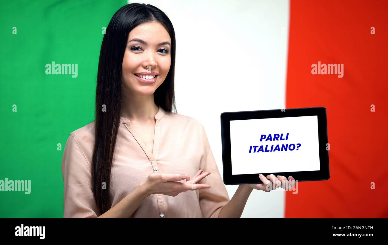 Woman holding tablet with do you speak italian phrase, app for learning ...