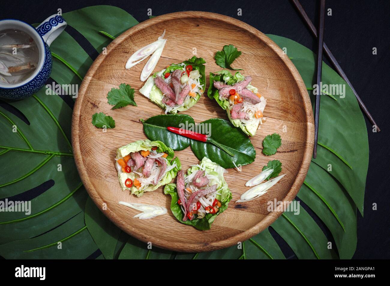 Spicy thai beef and lettuce canape with glass noodles Stock Photo - Alamy