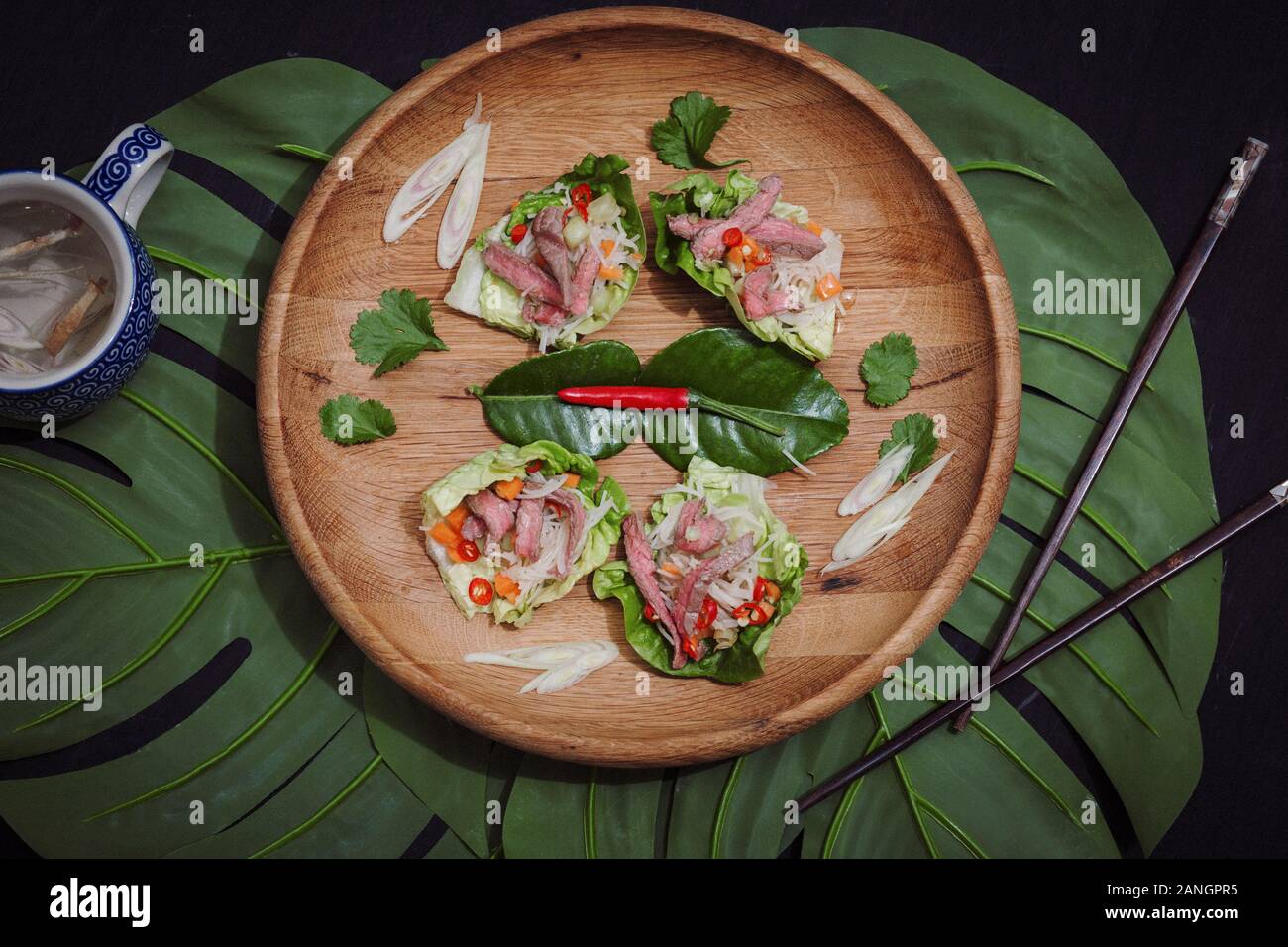 Spicy thai beef and lettuce canape with glass noodles Stock Photo - Alamy