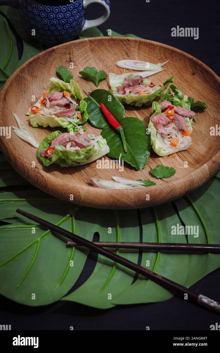 Spicy thai beef and lettuce canape with glass noodles Stock Photo - Alamy