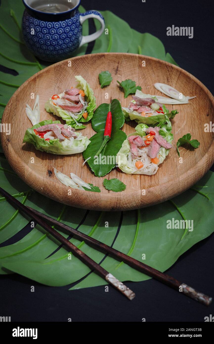 Spicy thai beef and lettuce canape with glass noodles Stock Photo - Alamy
