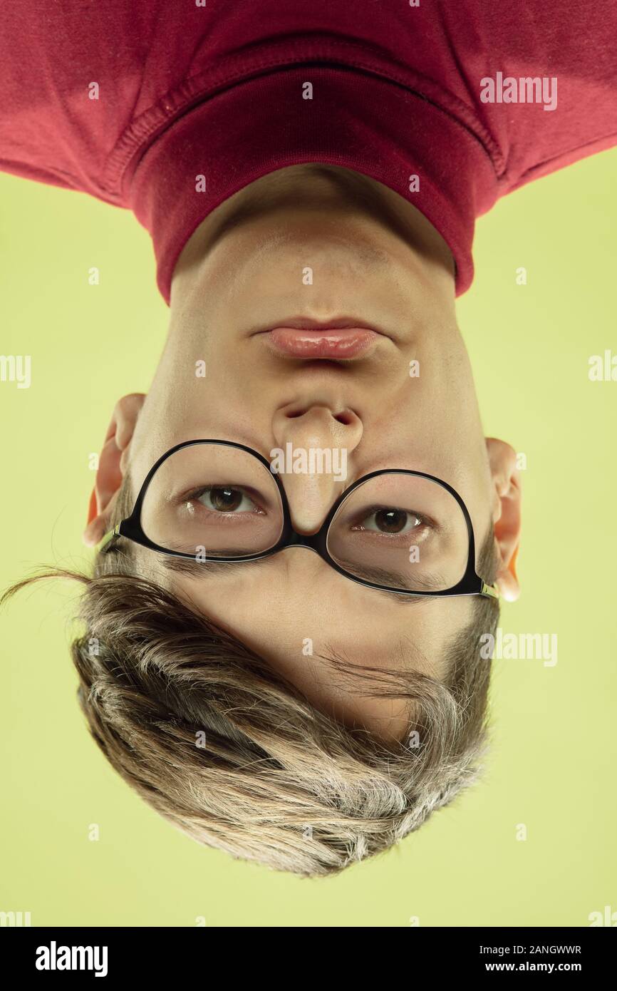 Looks calm and serious. Inverted portrait of caucasian young man on ...