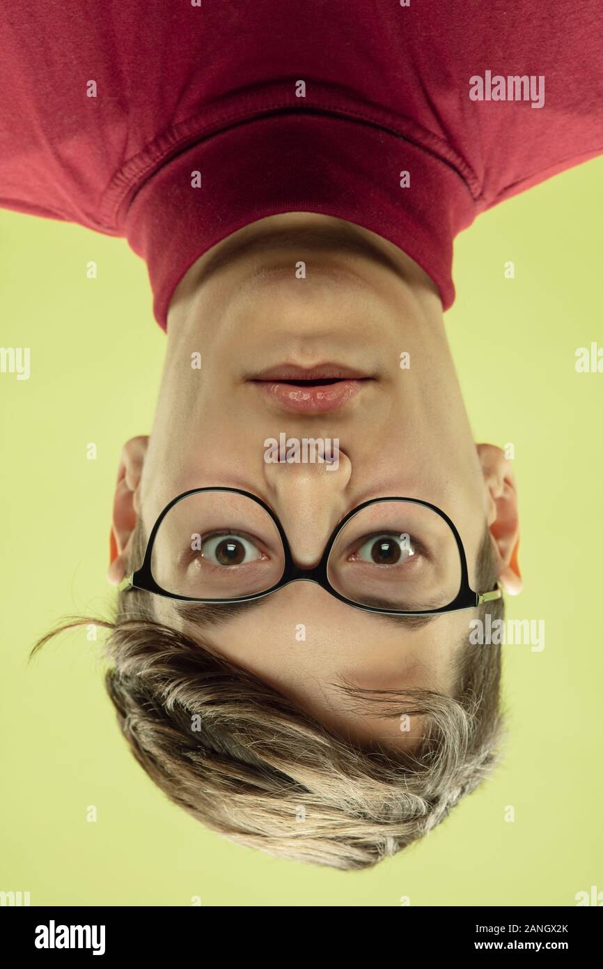 Looks calm and serious. Inverted portrait of caucasian young man on ...