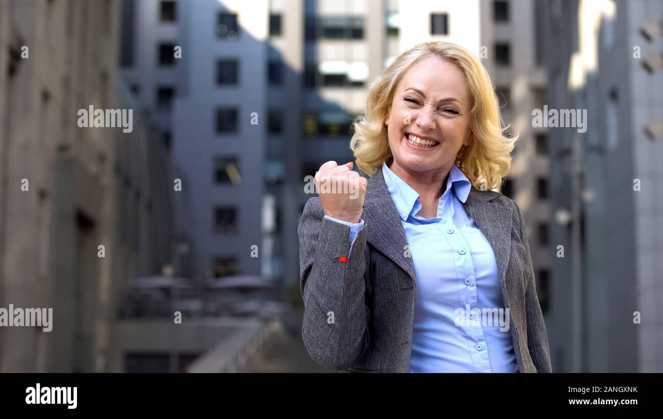Happy female boss showing success gesture, work achievement, business ...