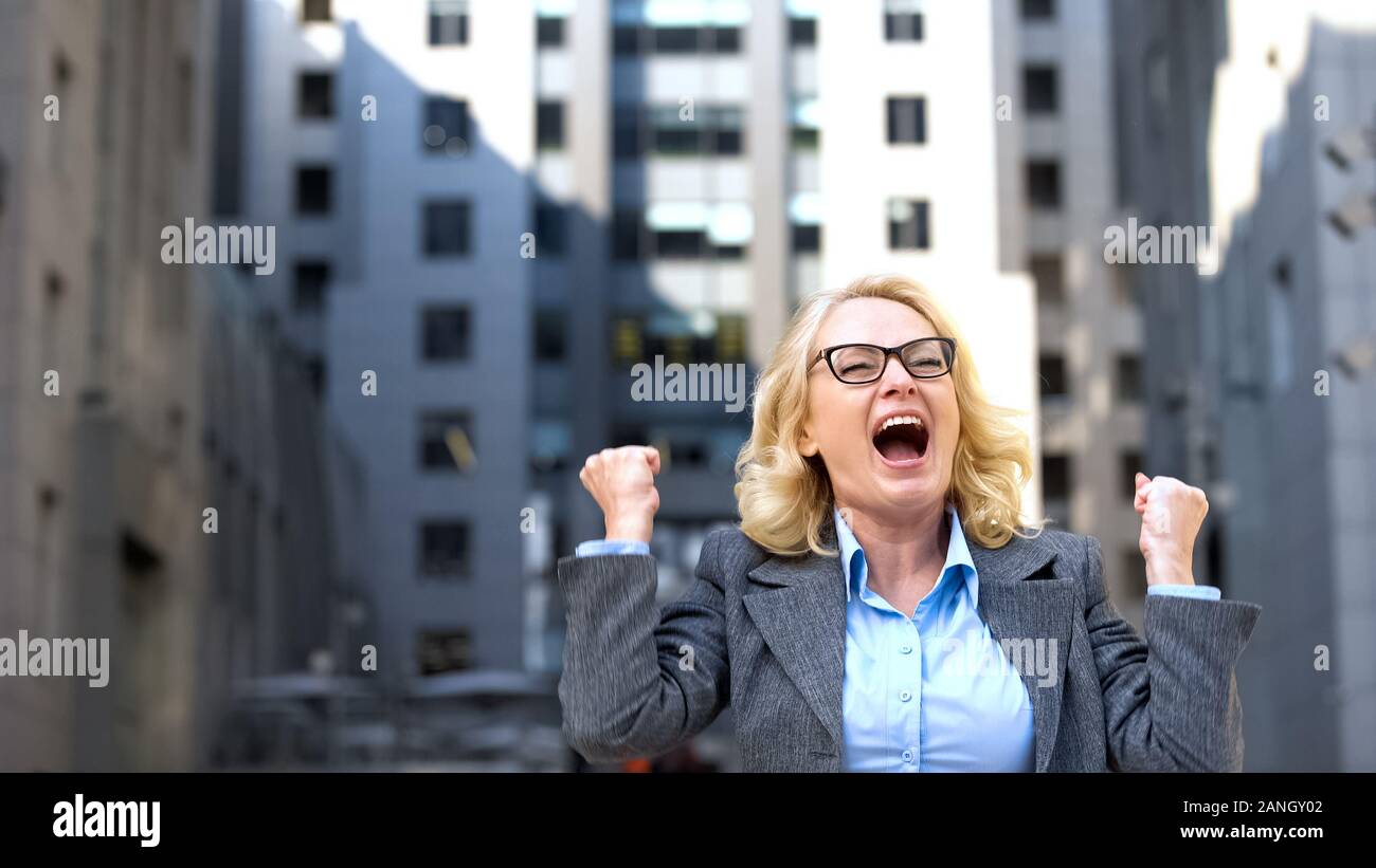 Happy female office worker celebrating success showing yes gesture ...