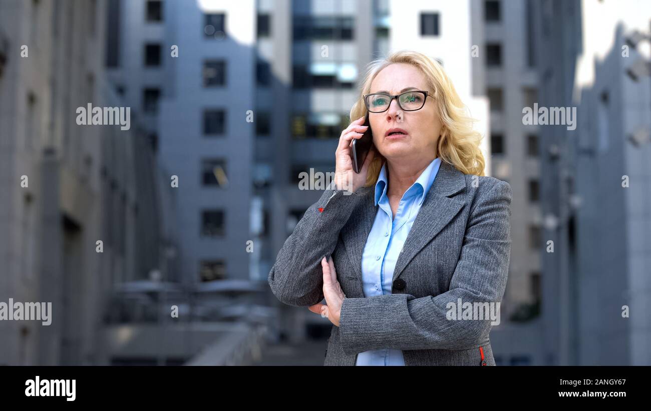 Shocked business woman talking phone outdoors office, bad news, work ...