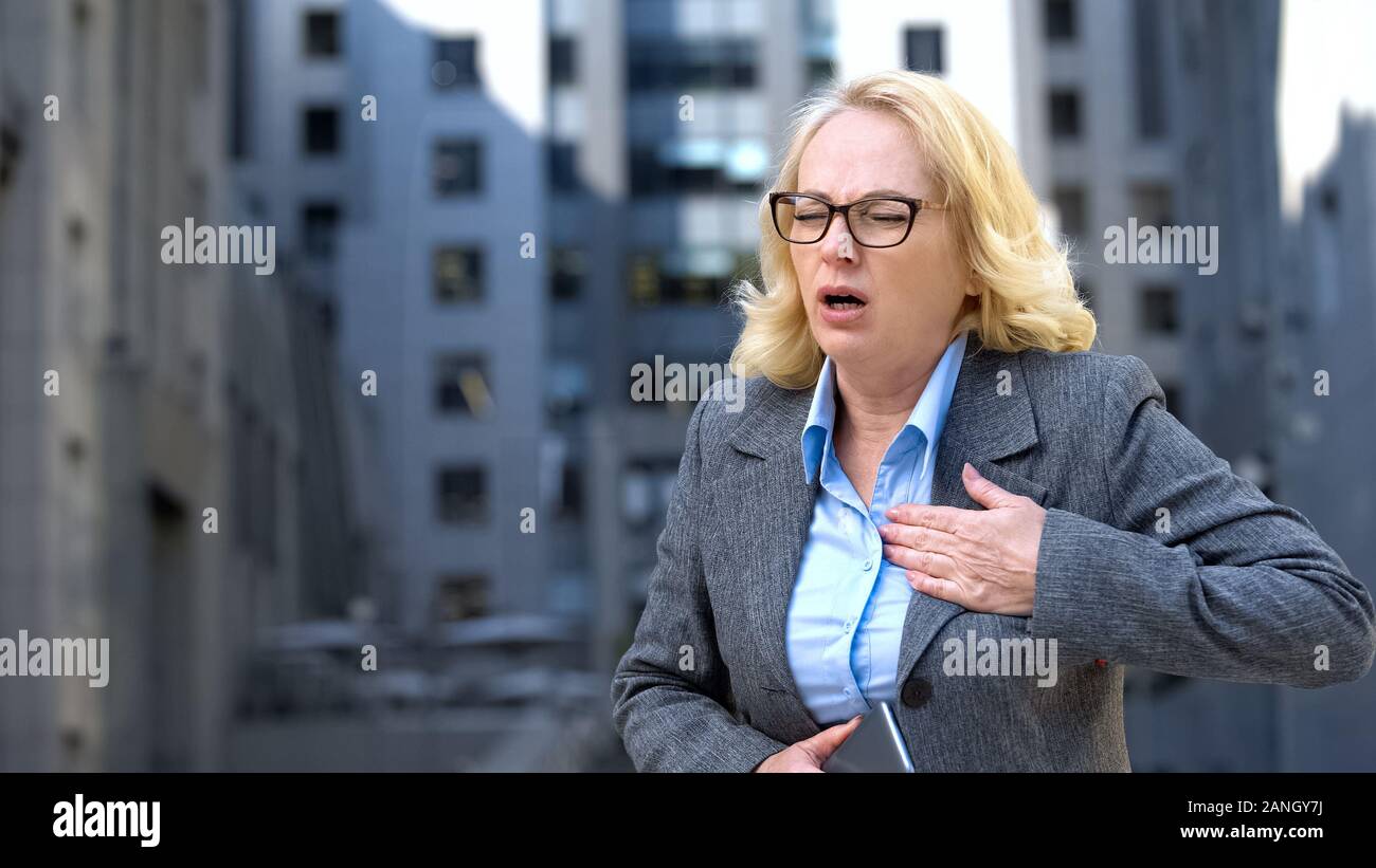 Senior company employee suffering heart attack at work, chest pain ...