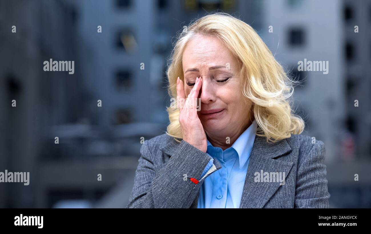 Sad crying female employee in formal suit, pension age unemployment ...