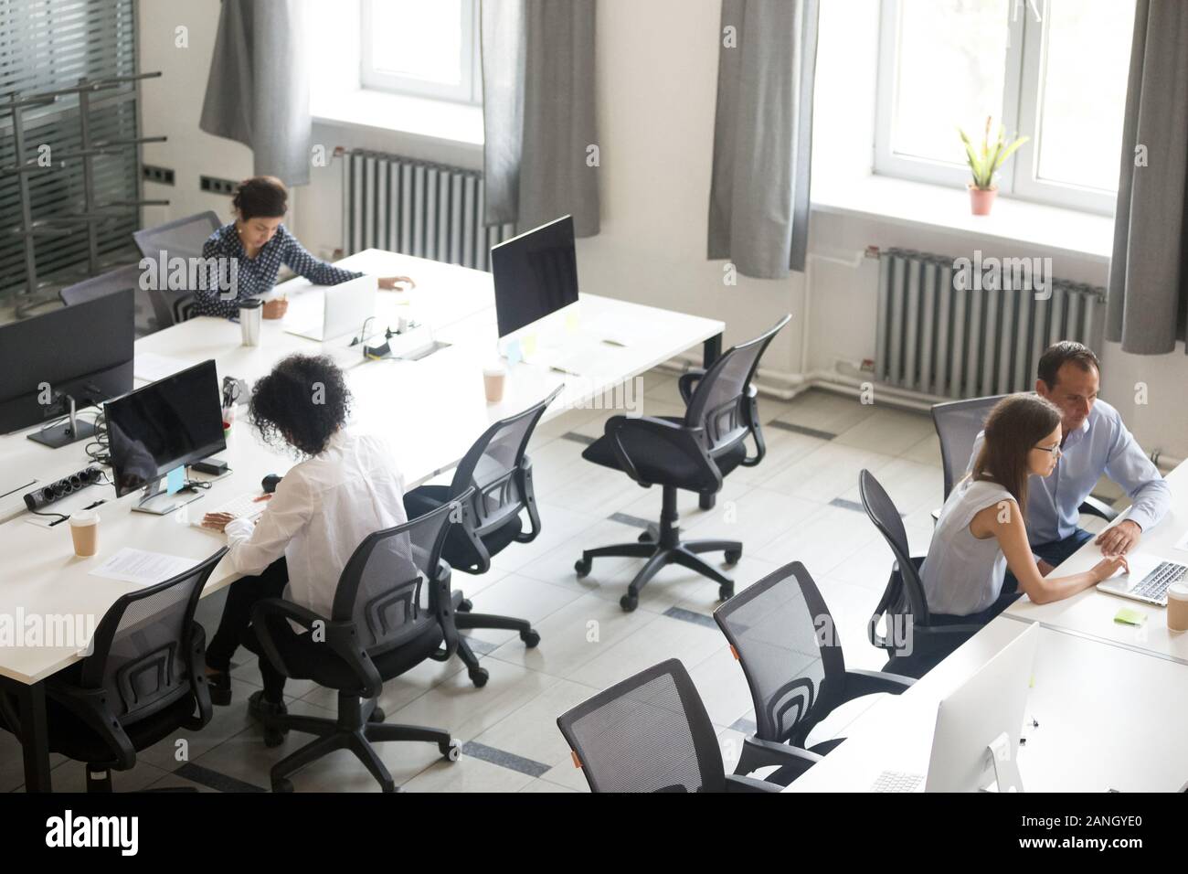 Top view of diverse people working at computers online in shared office ...