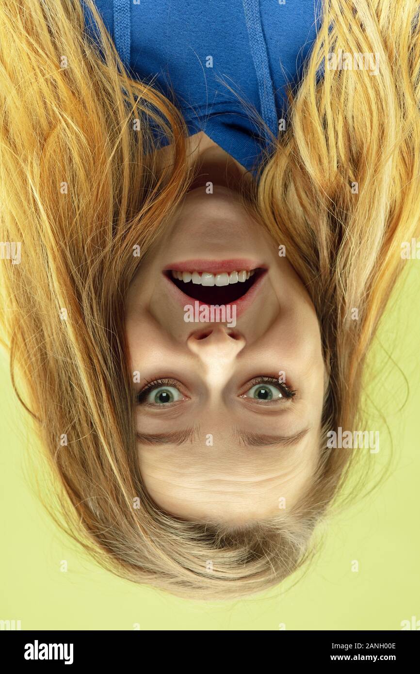 Shocked, astonished. Inverted portrait of caucasian young woman on ...