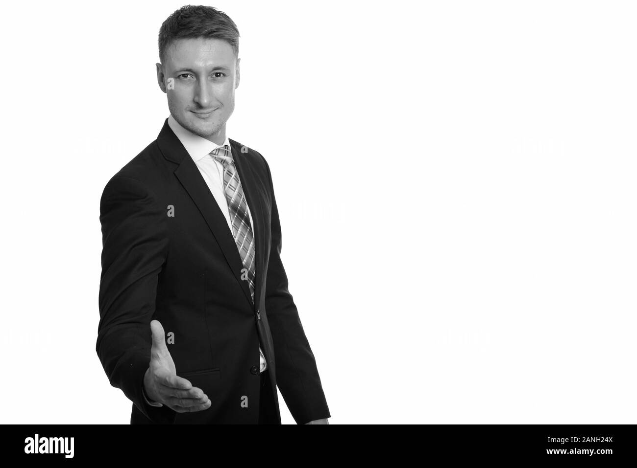 Young handsome man giving handshake hi-res stock photography and images ...