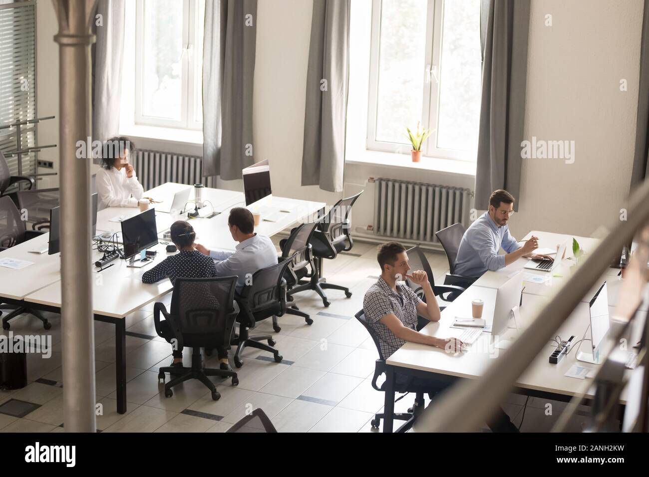 Top view of diverse people working together on computer performing ...