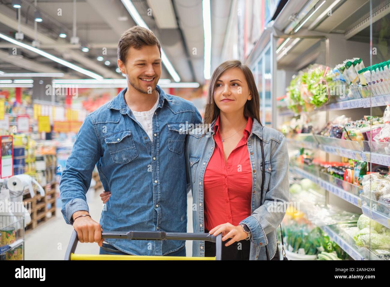 Couple choosing goods in a grocery store Stock Photo - Alamy
