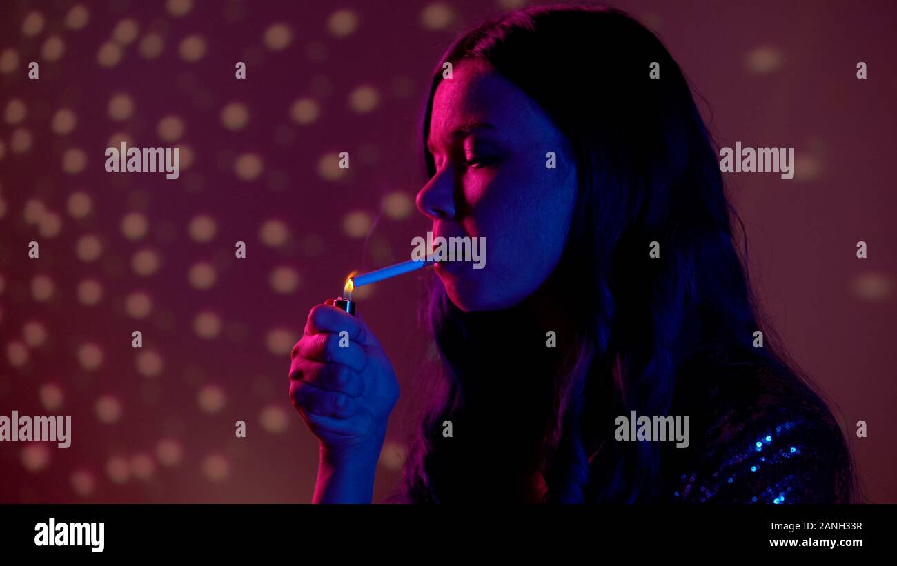 Woman lighting friends cigarette hi-res stock photography and images ...