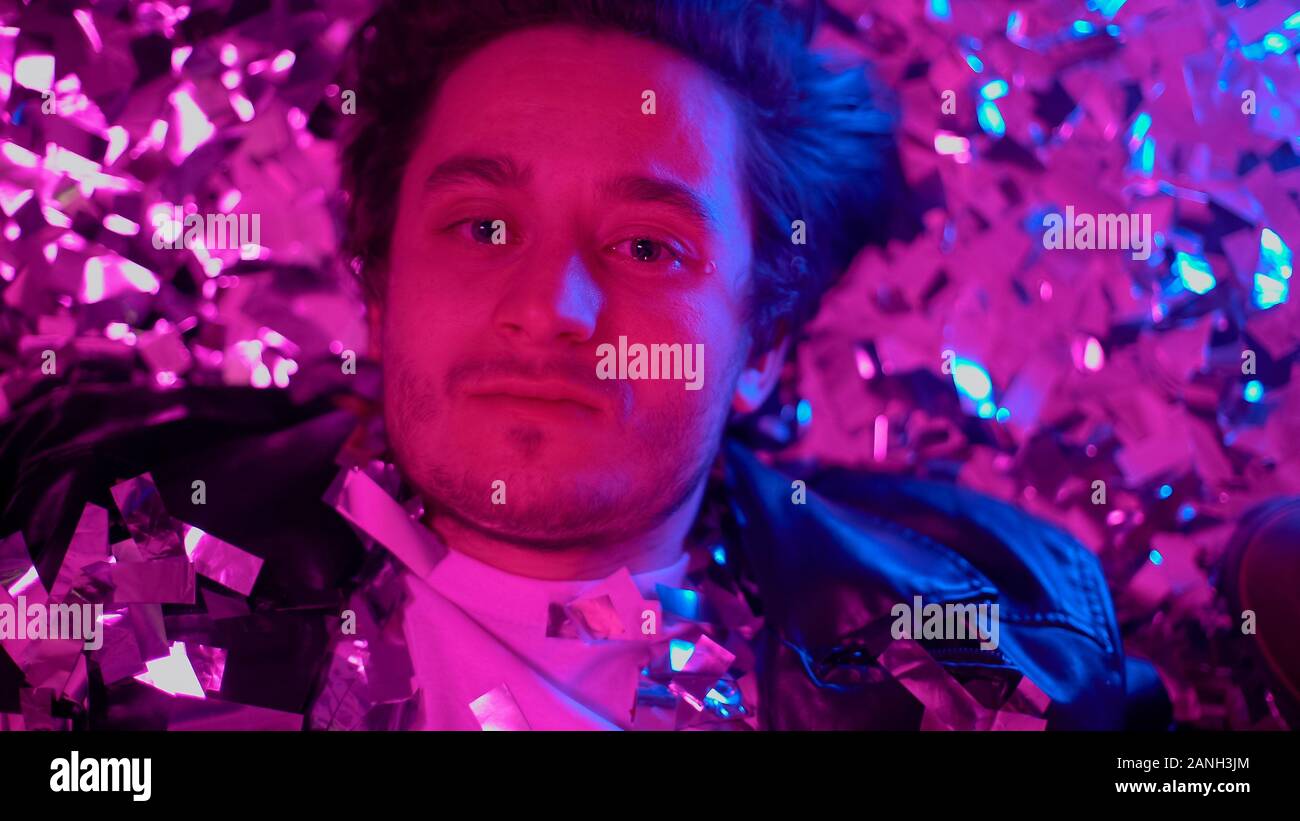 Drunk guy crying on floor at party, empty eyes staring at camera ...