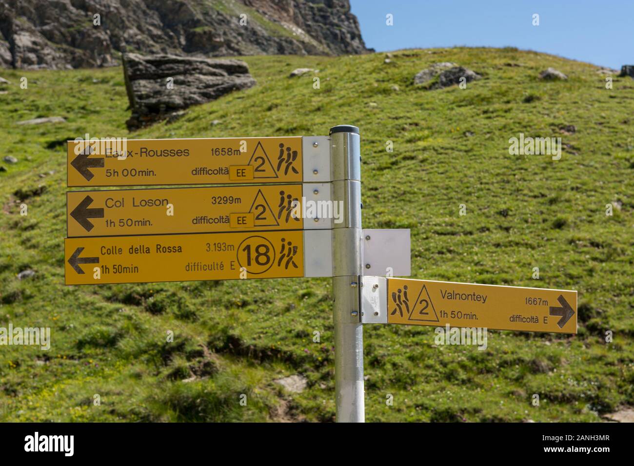 Yellow sign post indicating different hiking trails above Valnontey ...