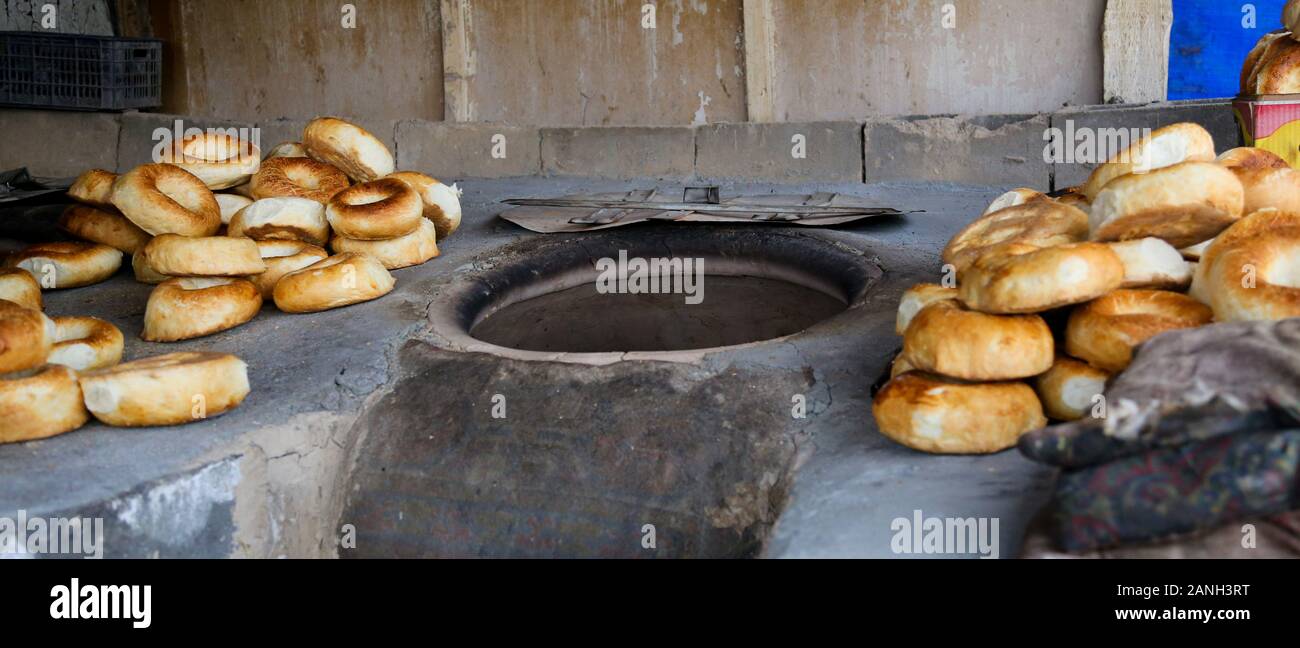 Taditional Kyrgiz local bakery oven with fresh bread of tandyr nan ...