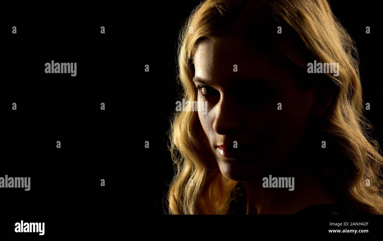 Devil woman looking at camera, black background, paranormal mystery ...