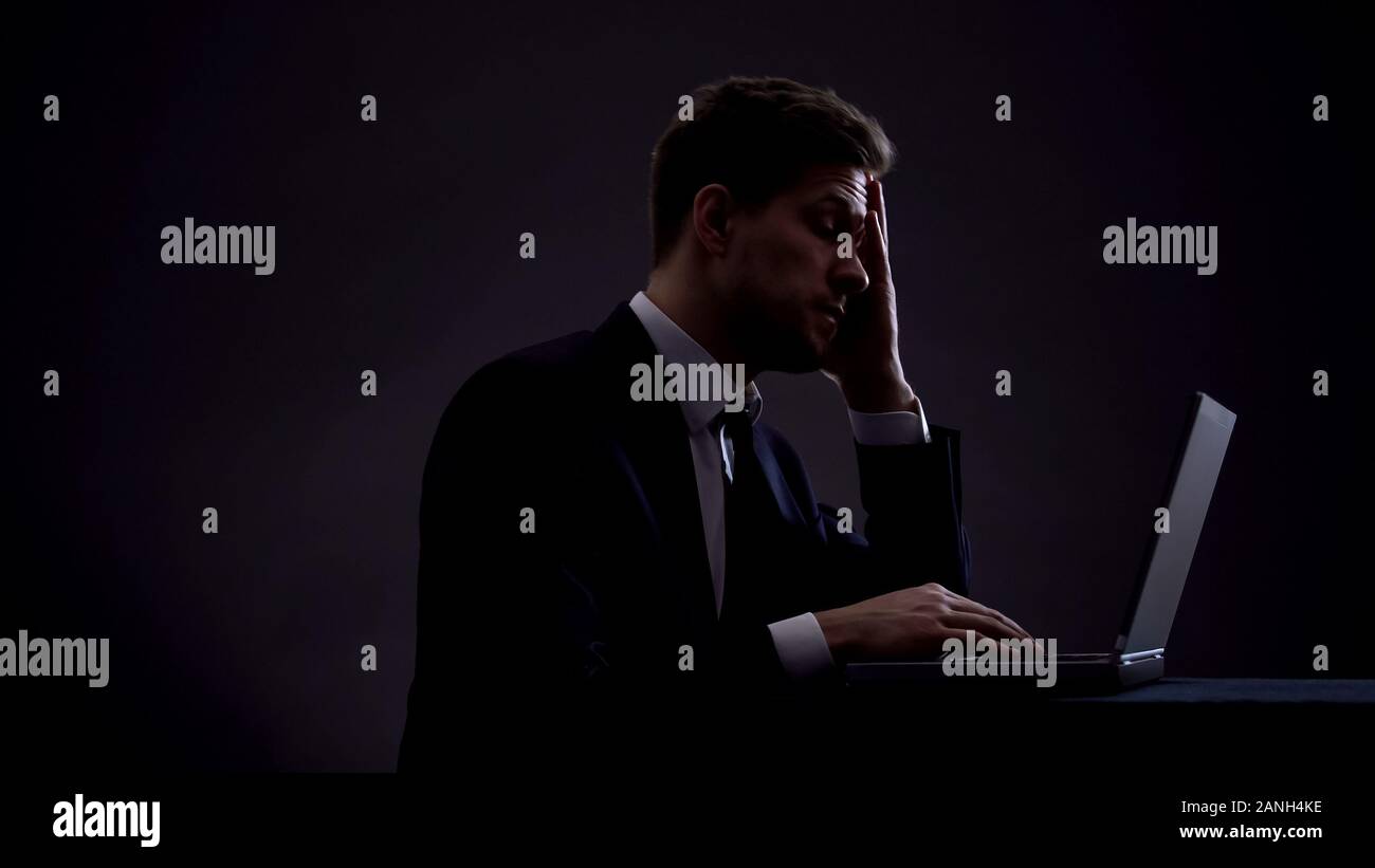 Tired business man working on laptop until late night, project ...