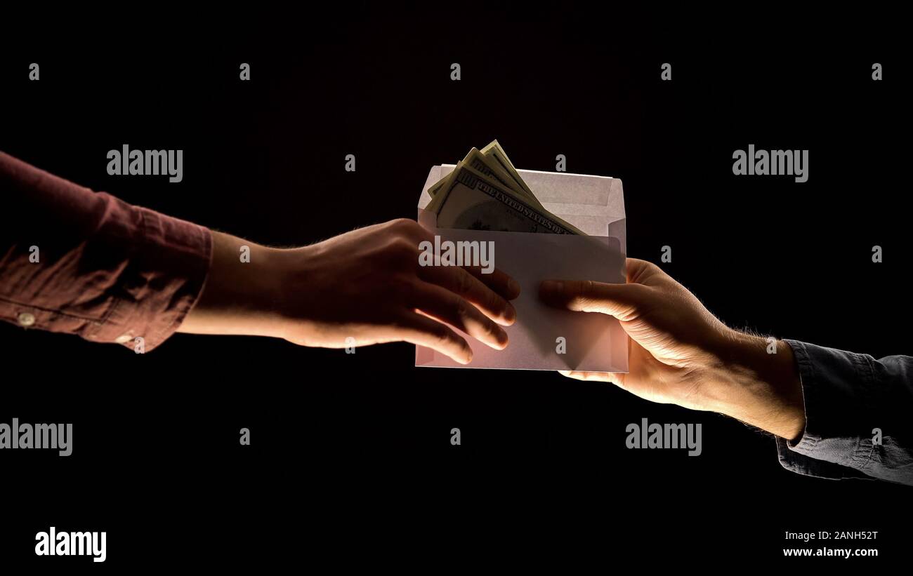 Man giving person envelope with dollars, bribery and corruption concept ...