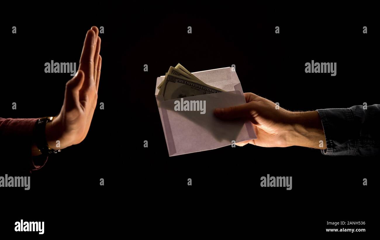 Male giving envelope with dollars, person making stop gesture, refusing ...