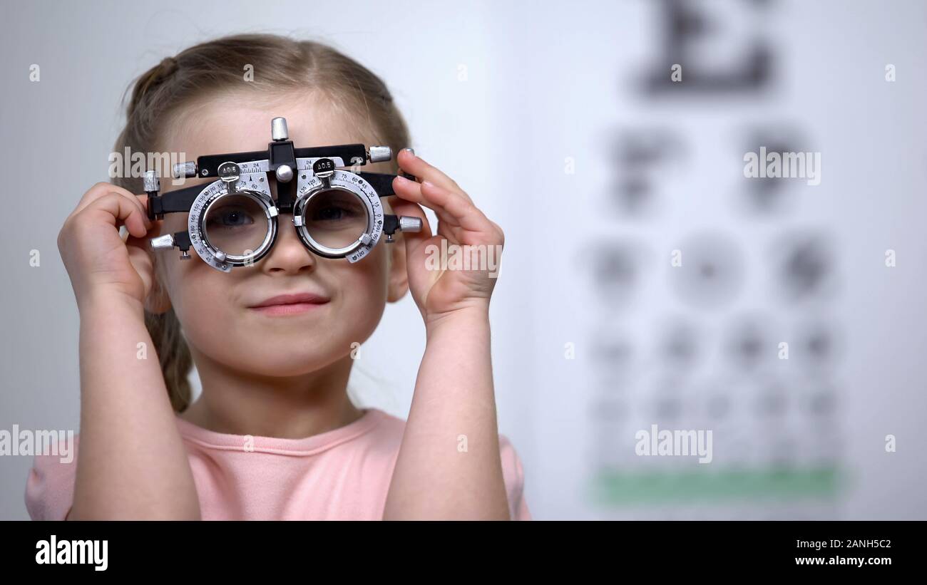 Pretty girl in optical trial frame smiling seeing clearly, vision ...