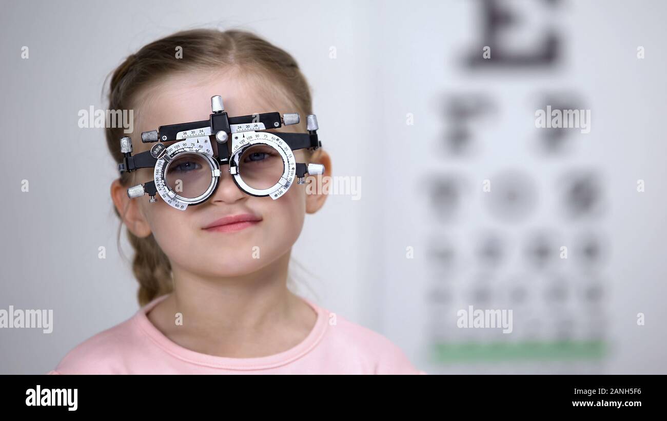 Little girl wearing eye testing glasses to diagnose vision ...
