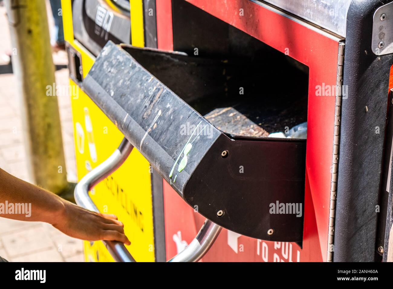 Female hand opens the lid of street rubbish bin - closeup Stock Photo ...