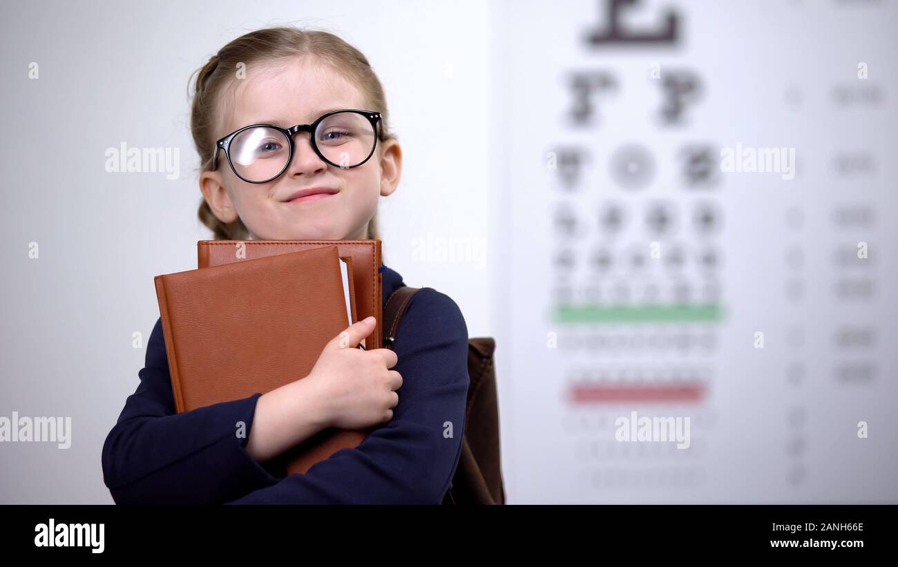 Bookworm kid in glasses hugging books, poor vision after reading too ...
