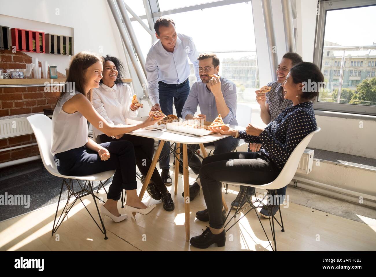 Happy Diverse Colleagues Spend Work Break Together Eating Takeaway