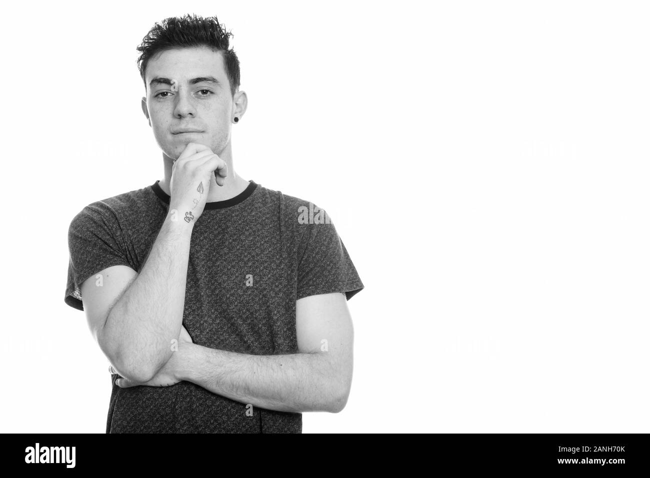 Studio shot of young man thinking Stock Photo - Alamy