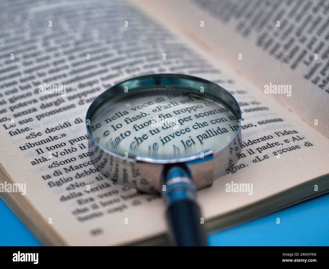 Magnifying glass and open book Stock Photo - Alamy