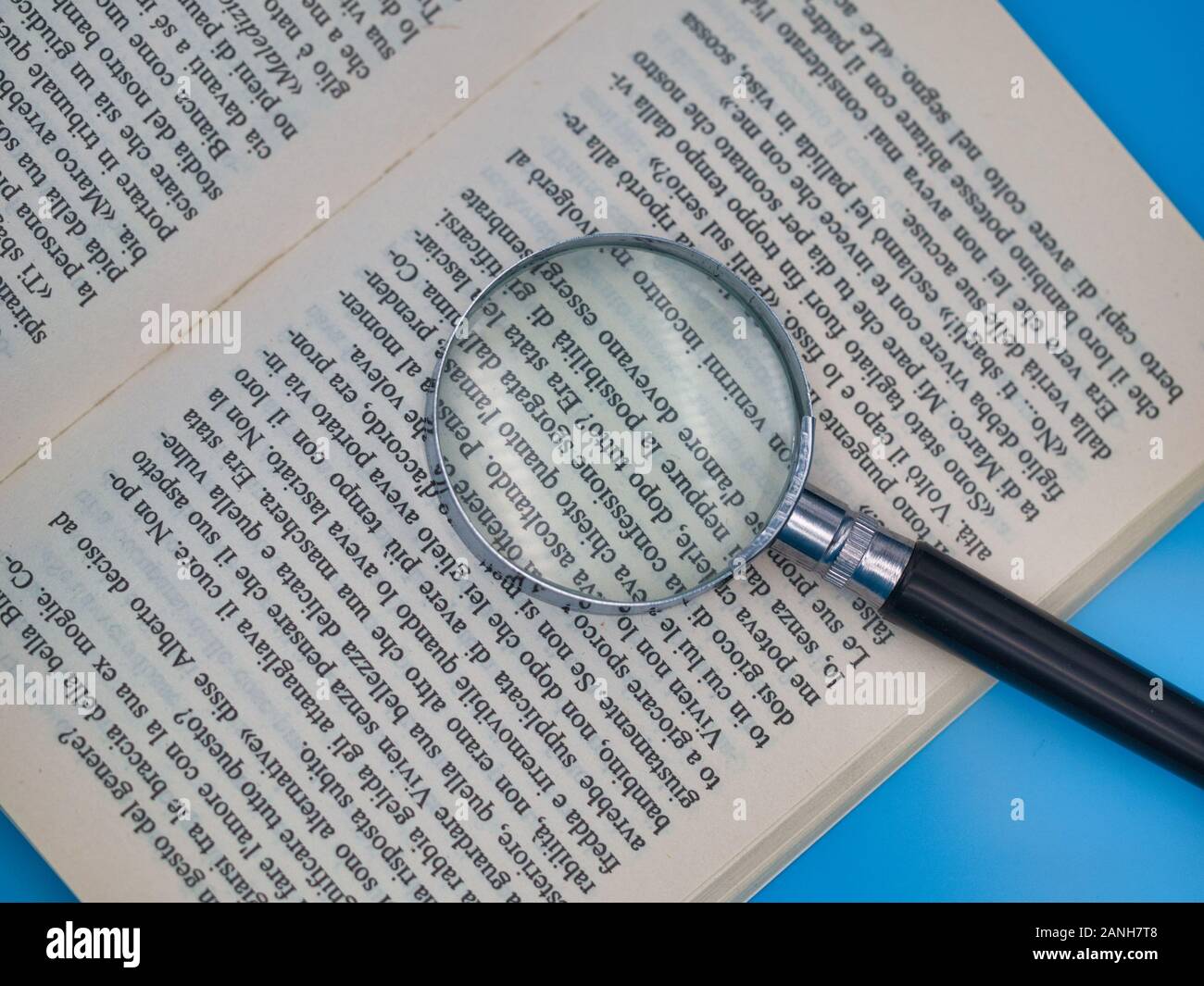 Magnifying glass and open book Stock Photo - Alamy