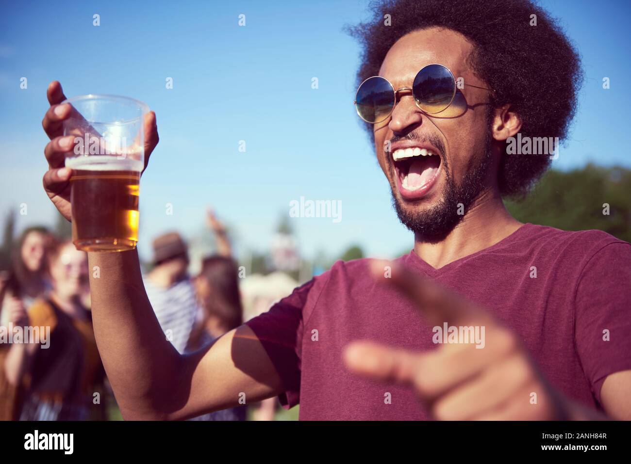 Screaming African man drinking beer at the music festival Stock Photo ...