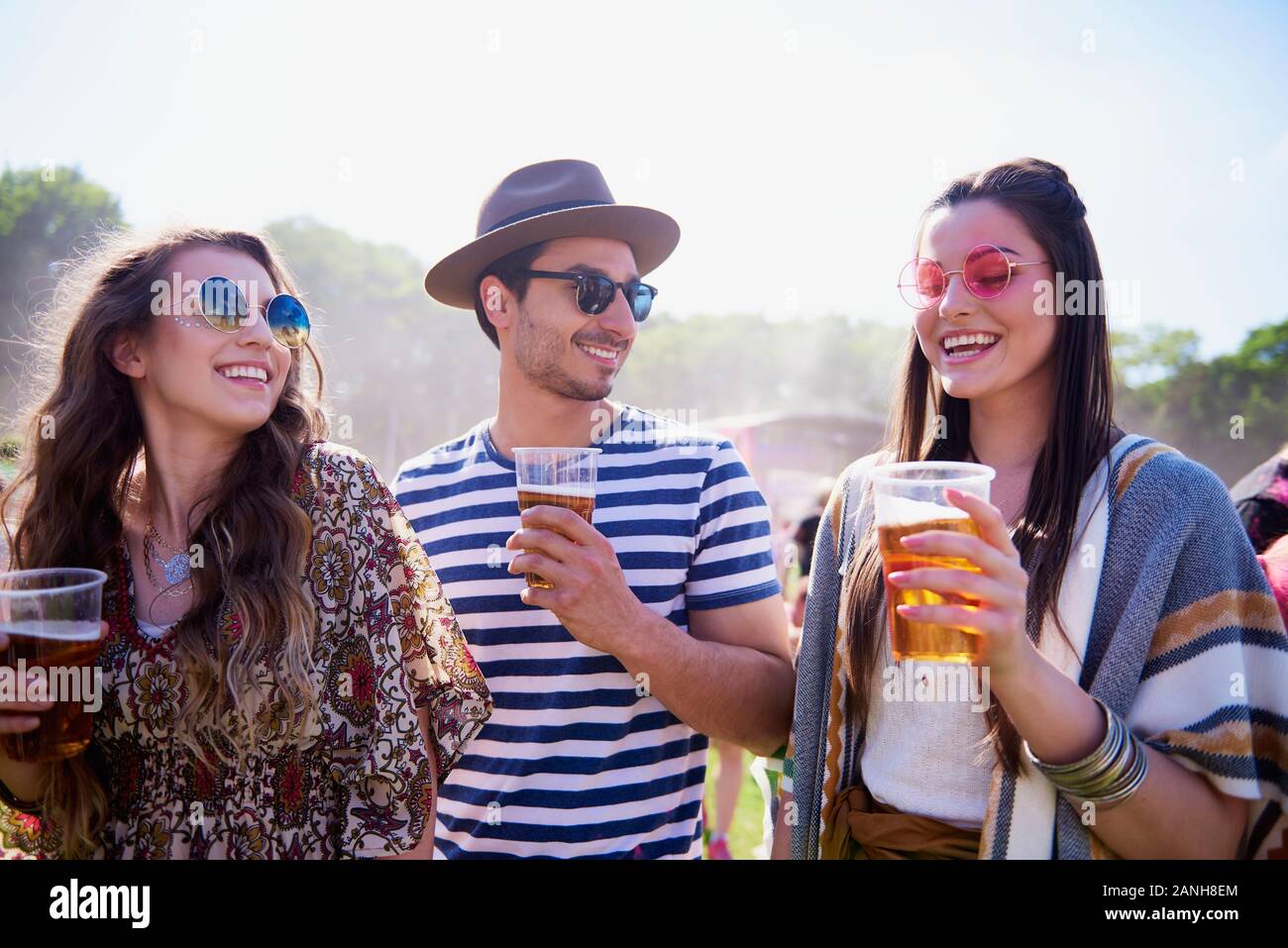 Three the best friends drinking beer outdoors Stock Photo - Alamy