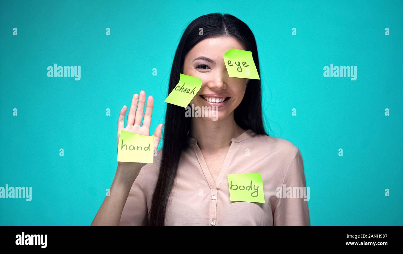 Female student covered with English body parts sticky notes, learning ...