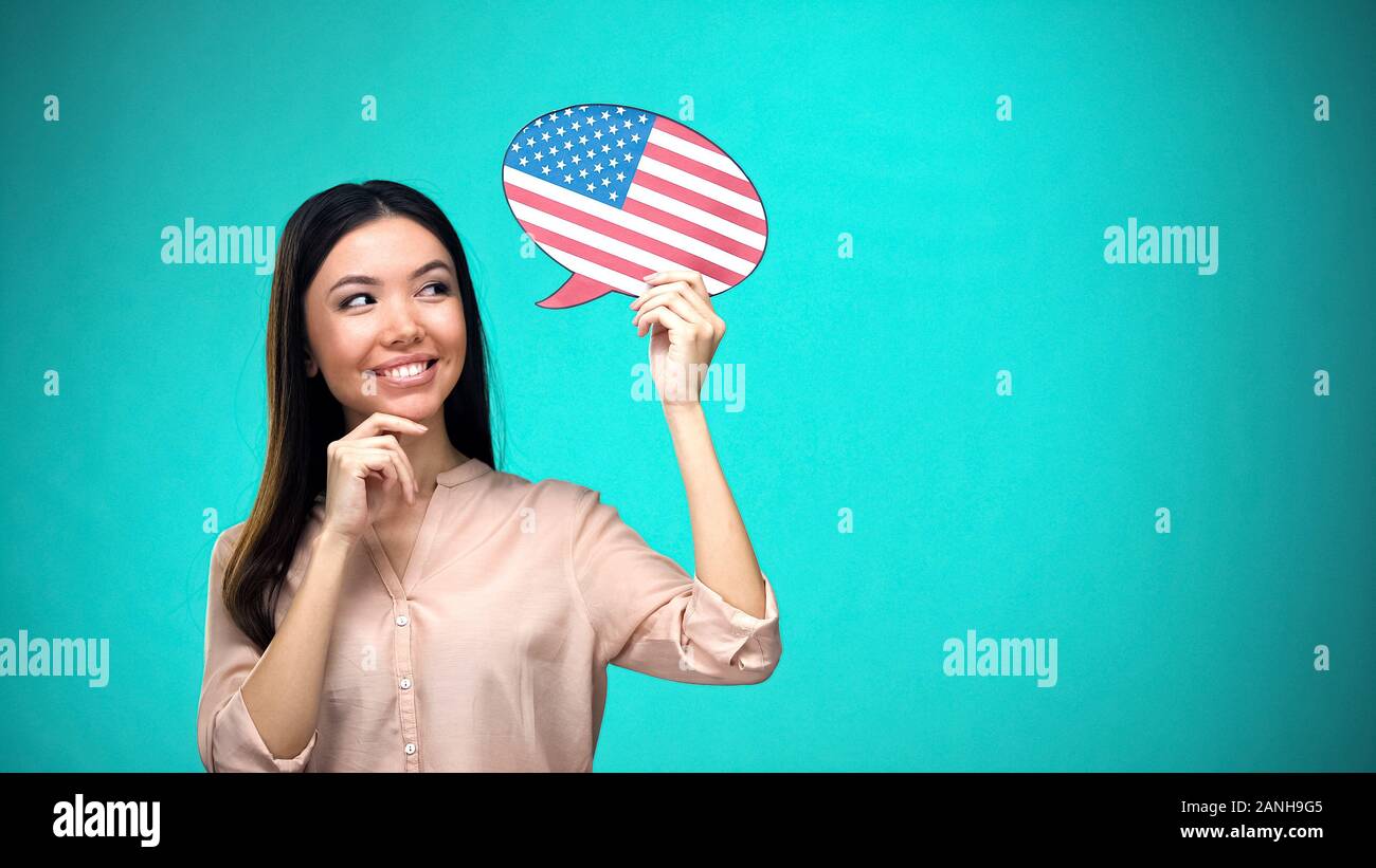 Curious woman holding USA flag sign, learning language, education ...