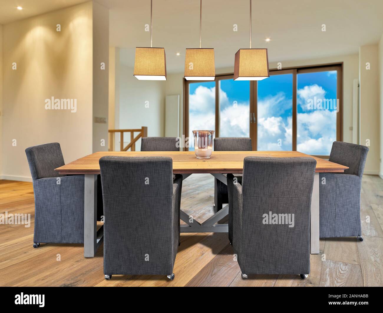 Modern interior with wooden floor and dining table from front Stock ...