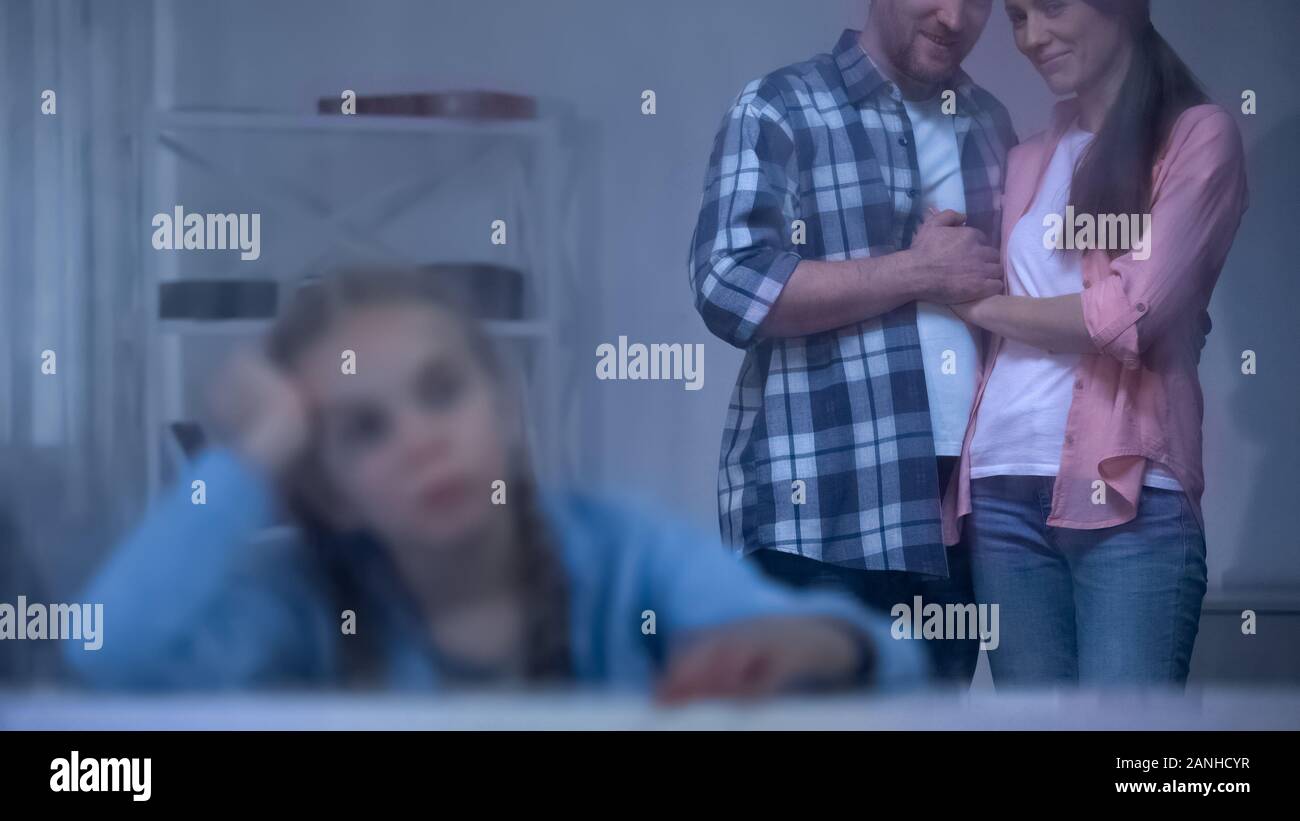 Sad orphan kid near rainy window, foster parents taking girl from ...