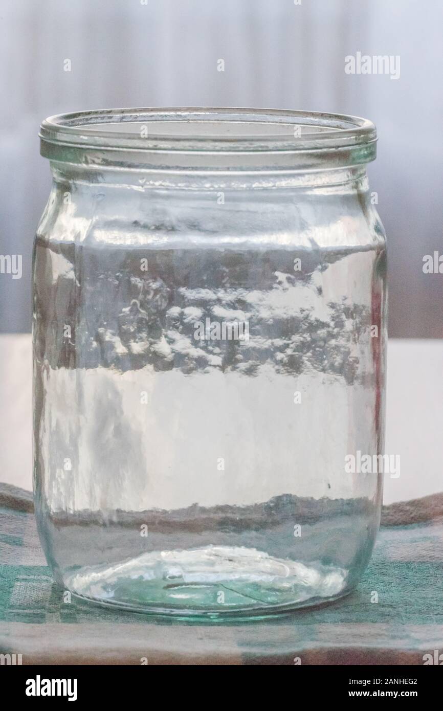 empty half-liter glass jar on the table, side view, closeup Stock Photo ...