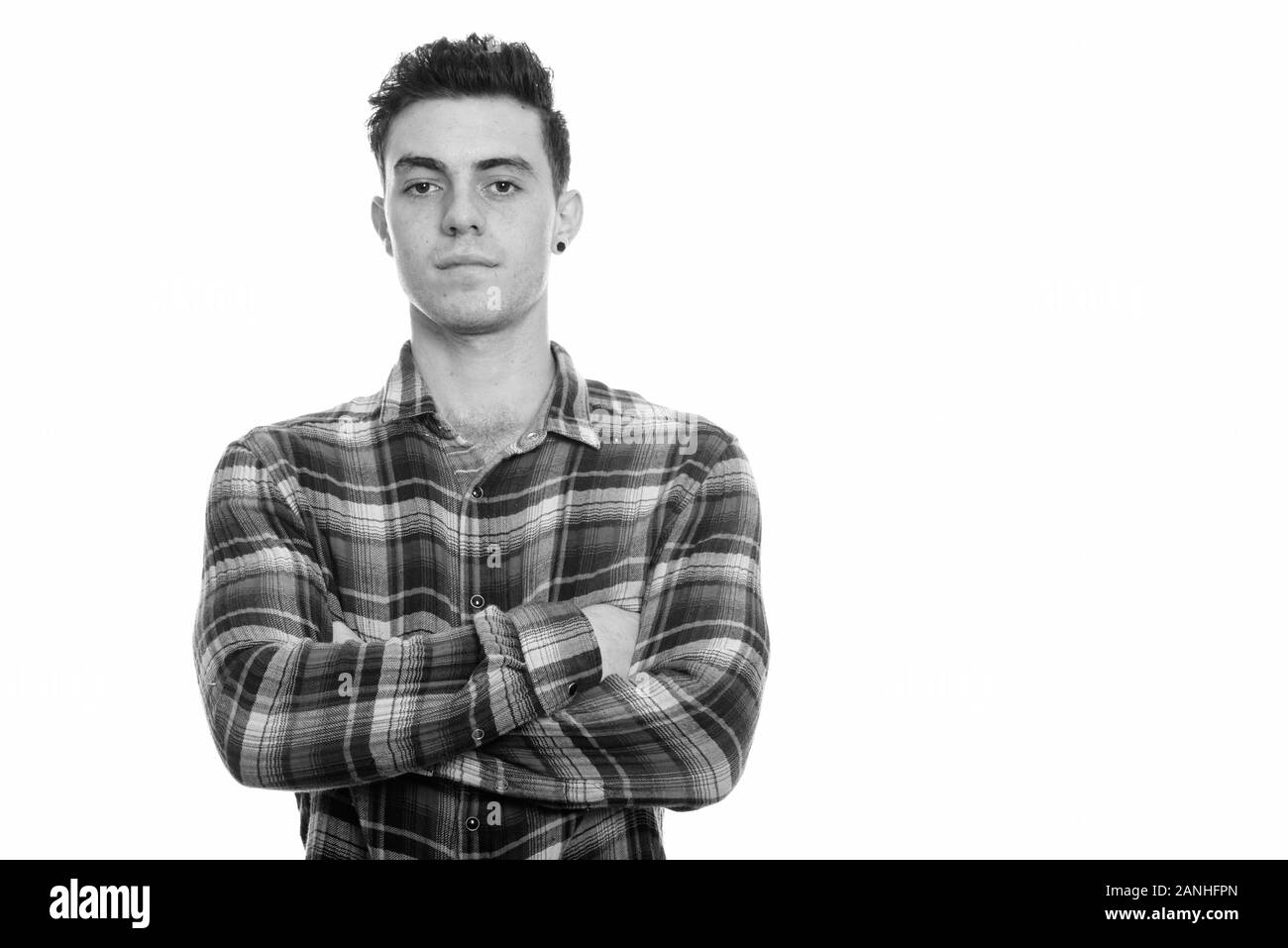 Studio shot of young man with arms crossed Stock Photo - Alamy