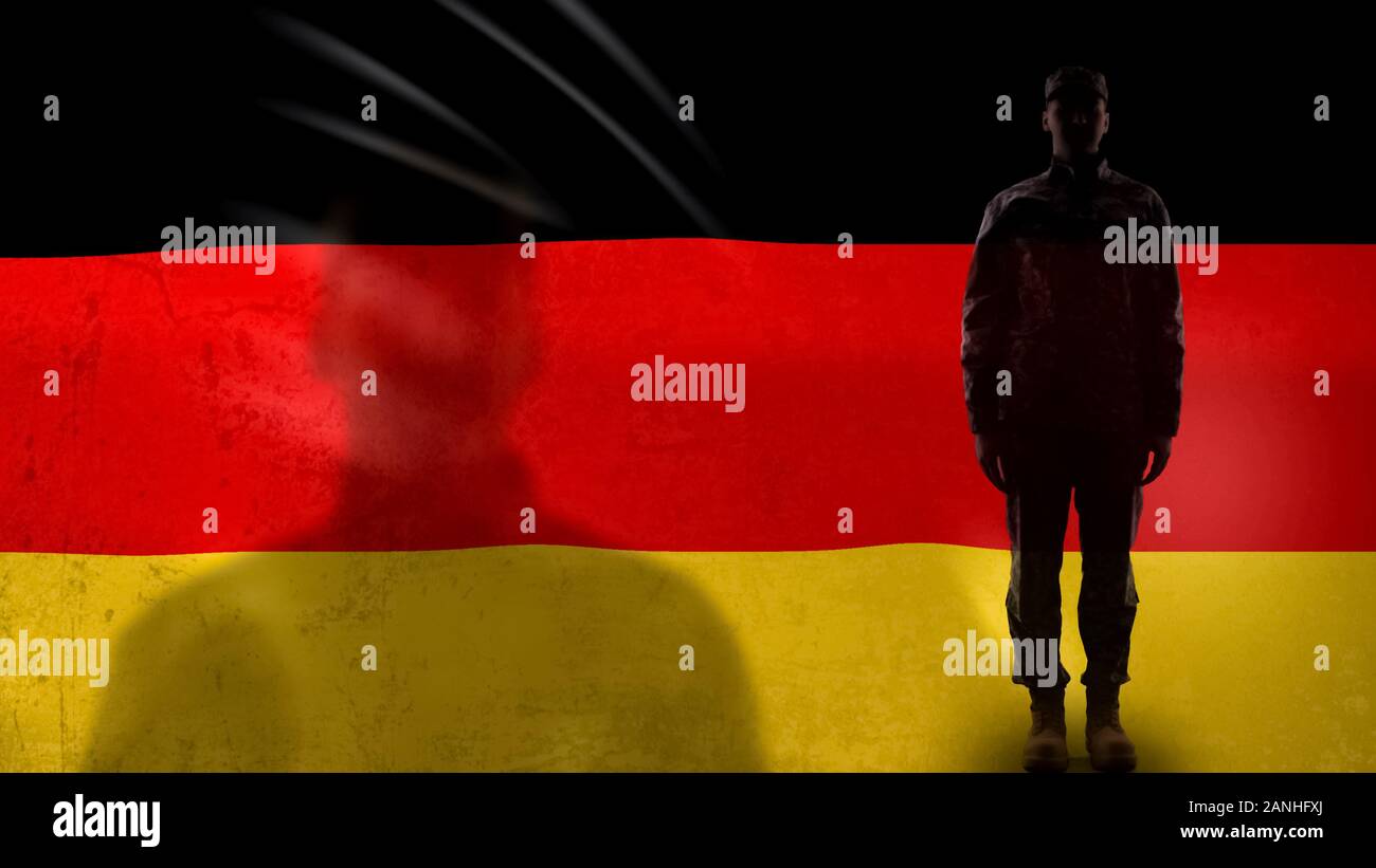 German soldier silhouette standing against national flag, proud army ...